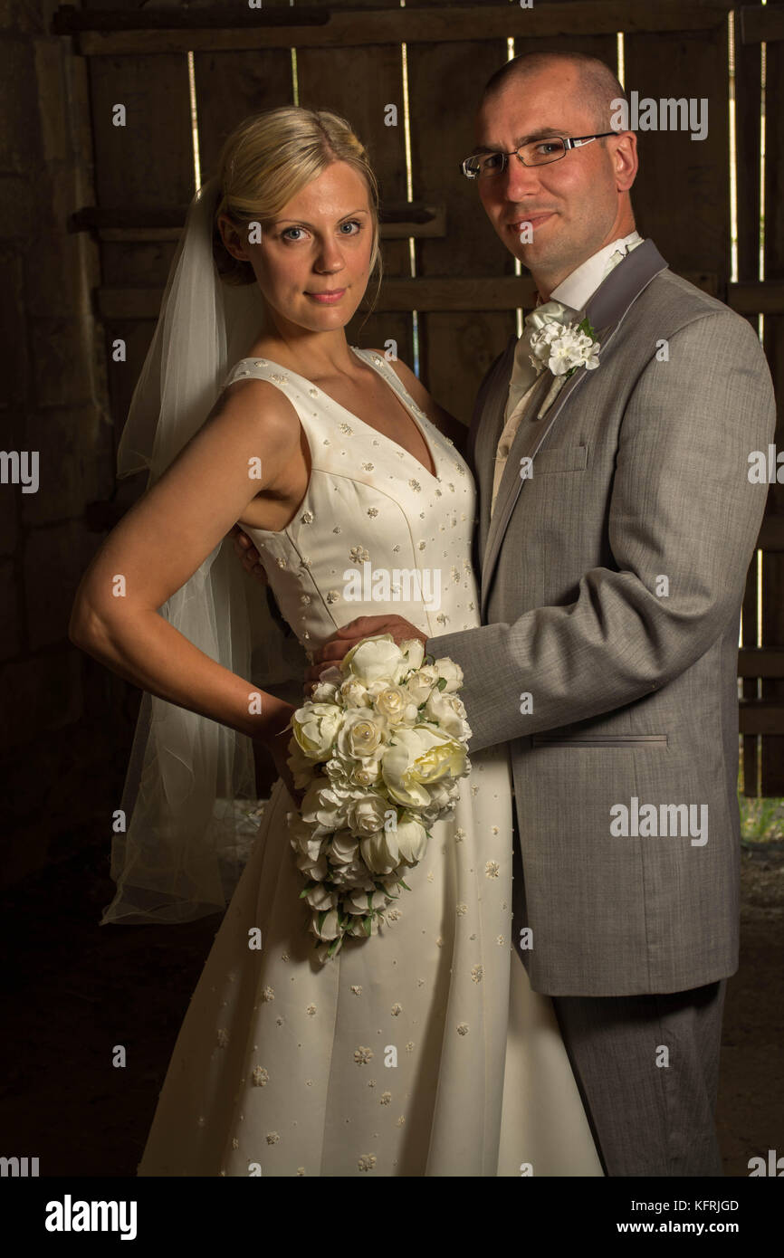 White Bride and groom with wedding dress and bouquet Stock Photo - Alamy