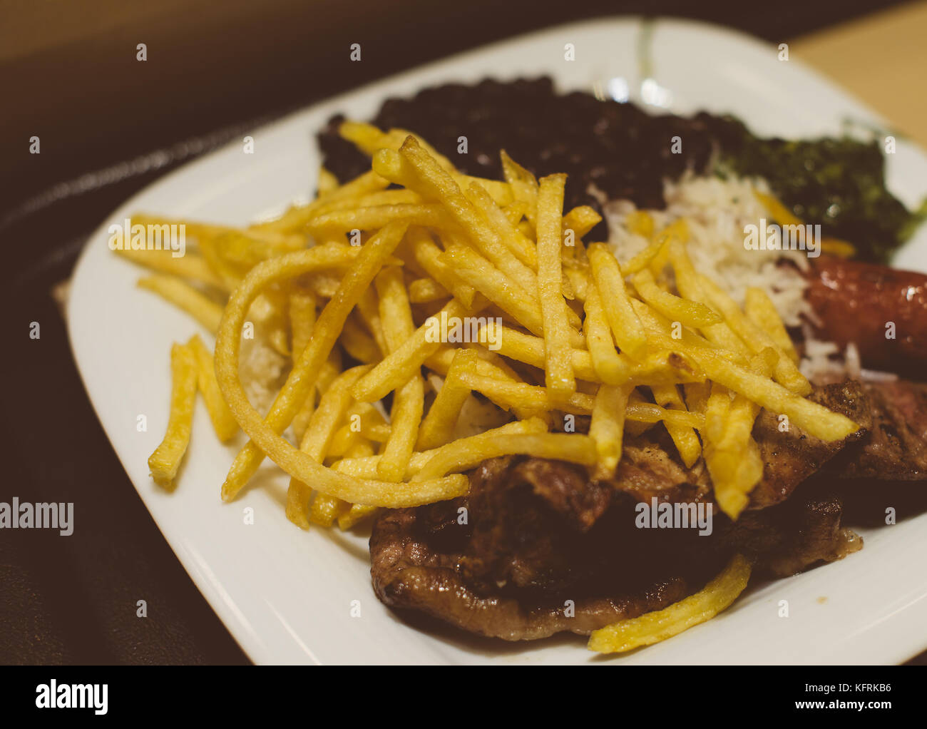 Junk food concept. French fries with rice and fried meat Stock Photo ...