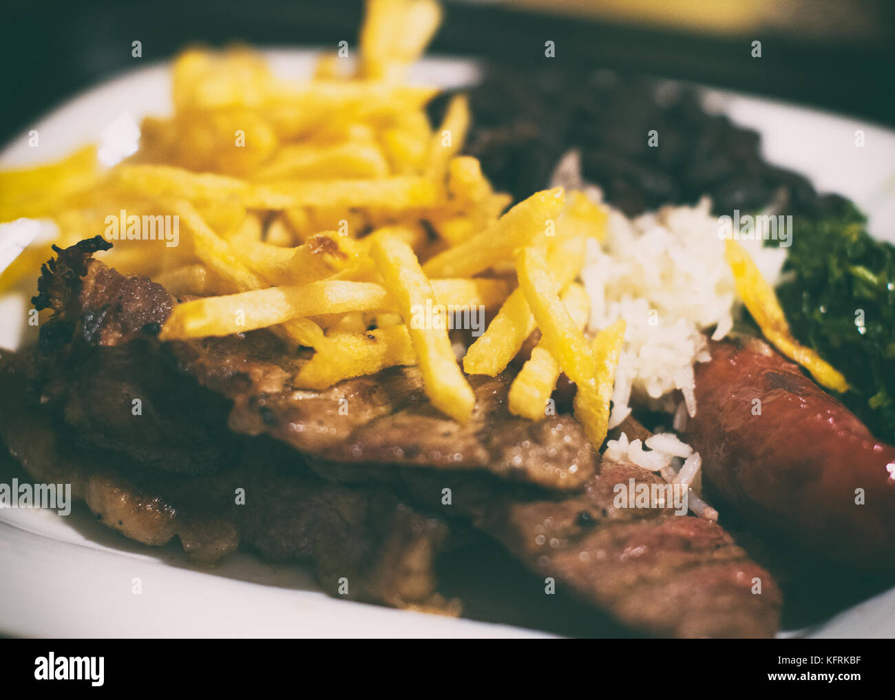 Junk food concept. French fries with rice and fried meat Stock Photo ...