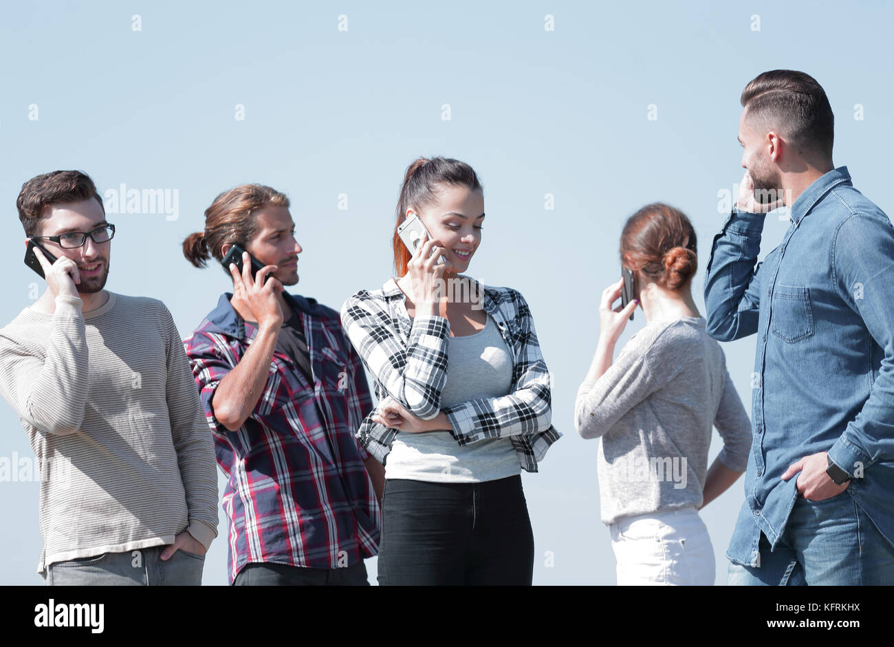 group of young people talking on their smartphones.photo with copy ...