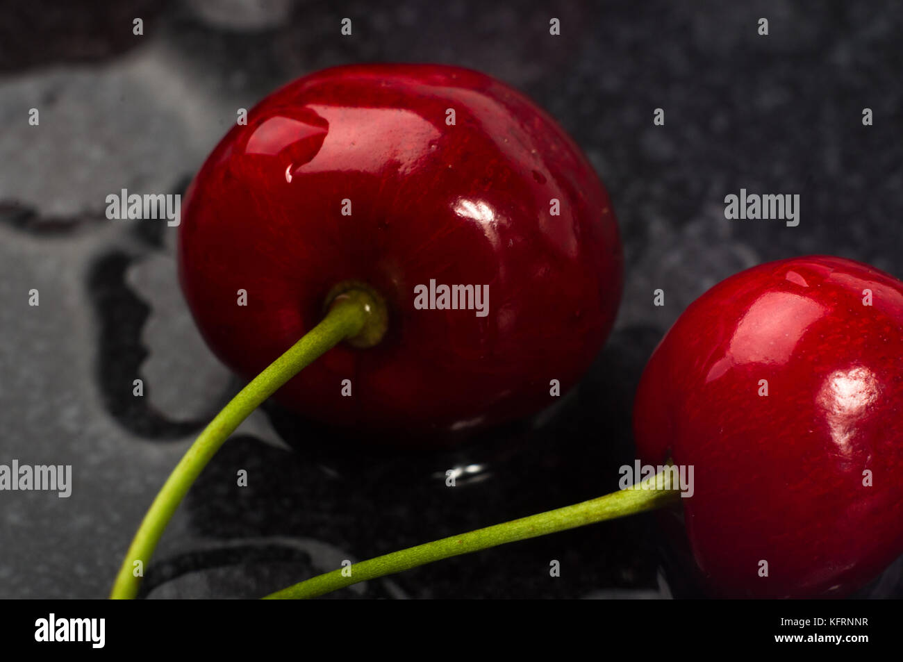 large ripe red sweet cherries in a dish of stainless steel, close-up ...