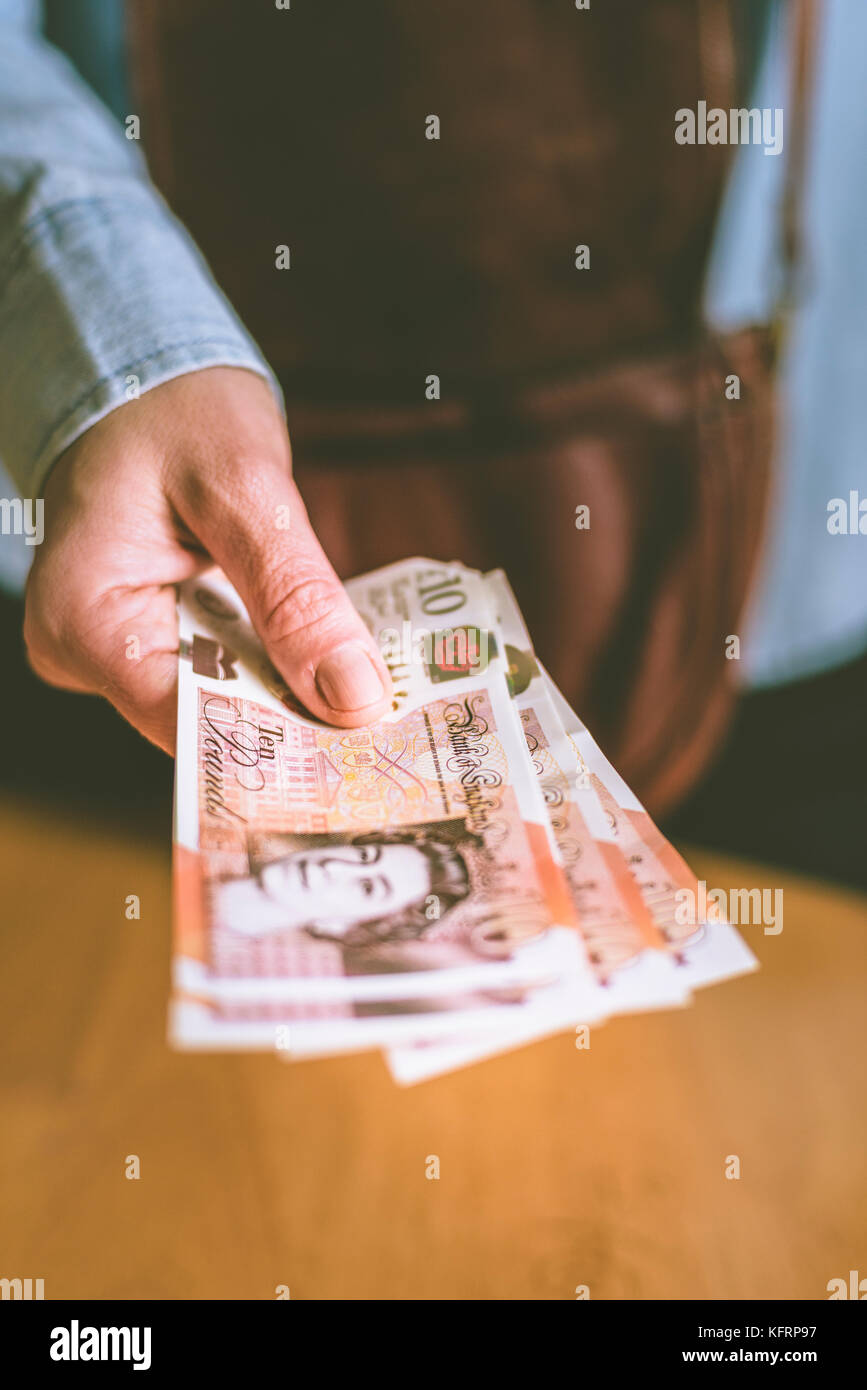 London-UK - October 24, woman taking some 10 pound notes out of her ...