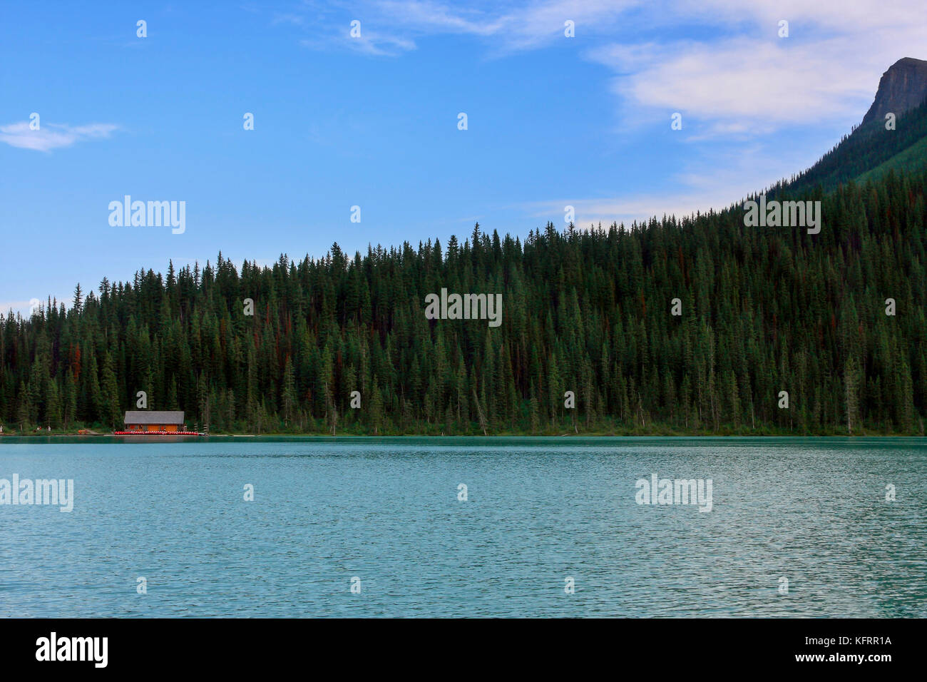 Calm and peaceful Lake Louise and a boat house at Banff national park ...