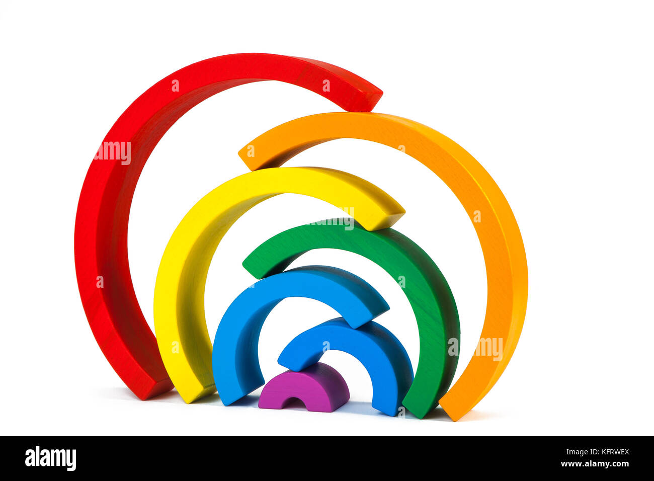 A wooden toy of seven different-colored arcs in the form of a rainbow ...