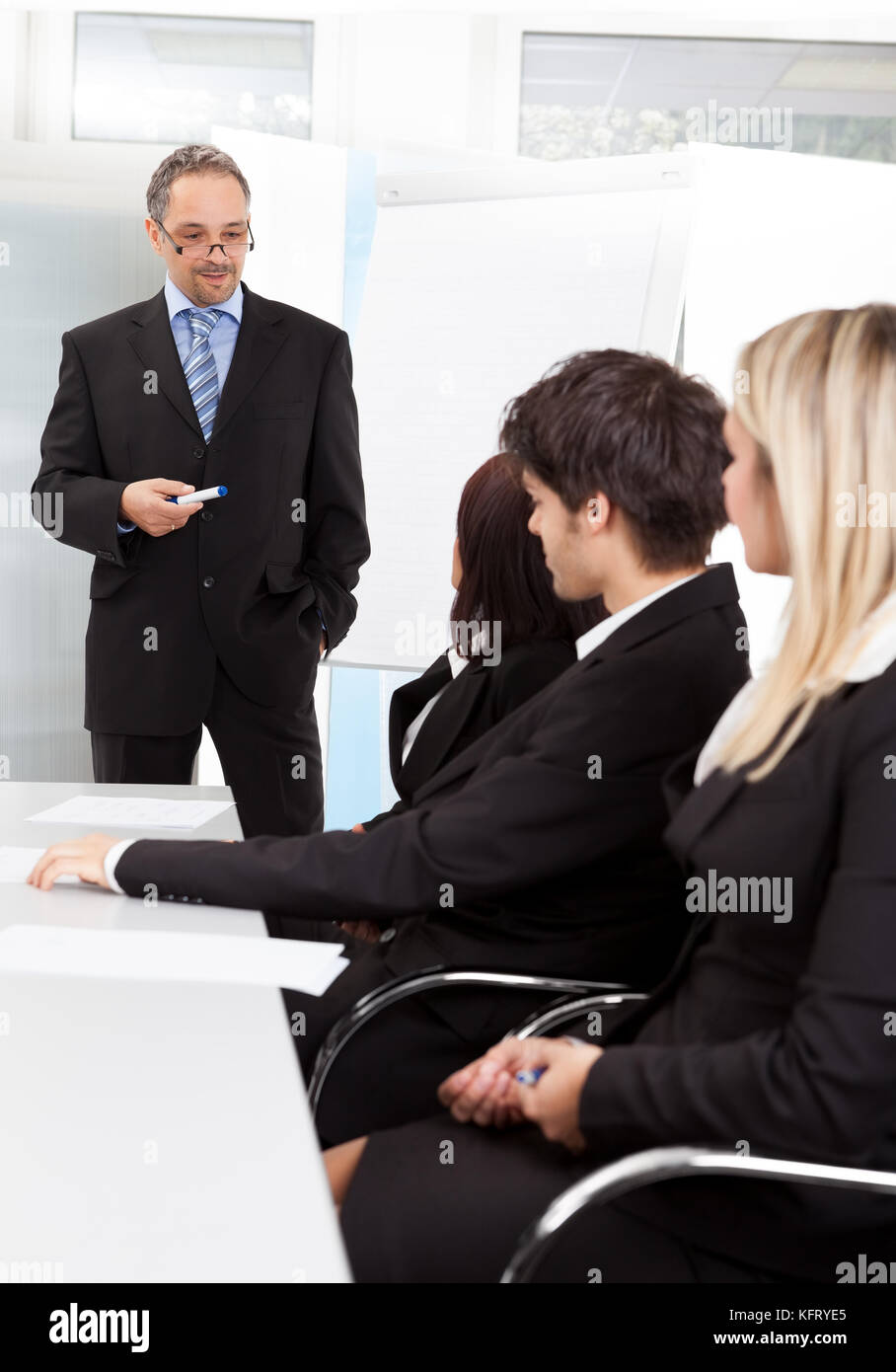 Group of business people at presentation in the office Stock Photo - Alamy