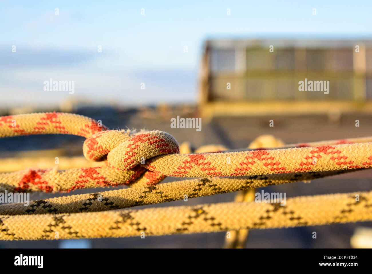 Closeup stretched and tied industrial braided rope Stock Photo - Alamy