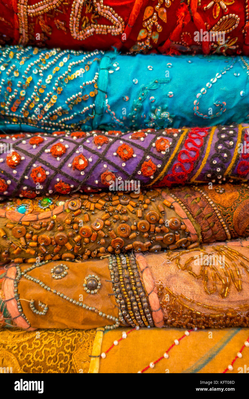 Close up of heap of cloth fabrics at a local market in India, vertical ...