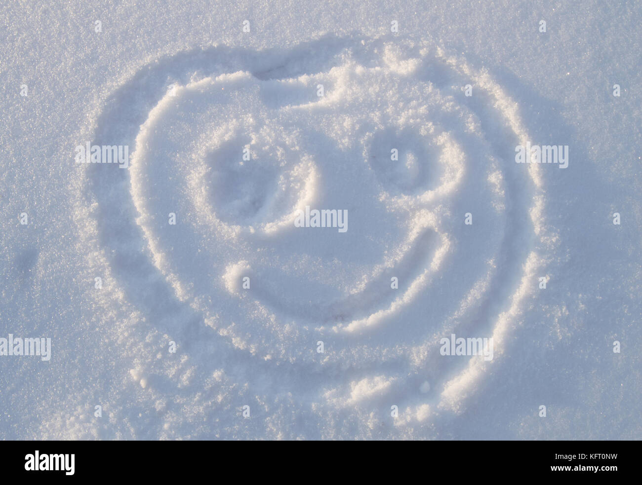Smiling face is drawn on a snow Stock Photo - Alamy