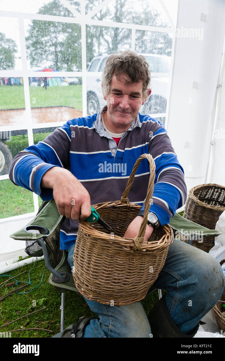 Man making wicker basket Stock Photo - Alamy