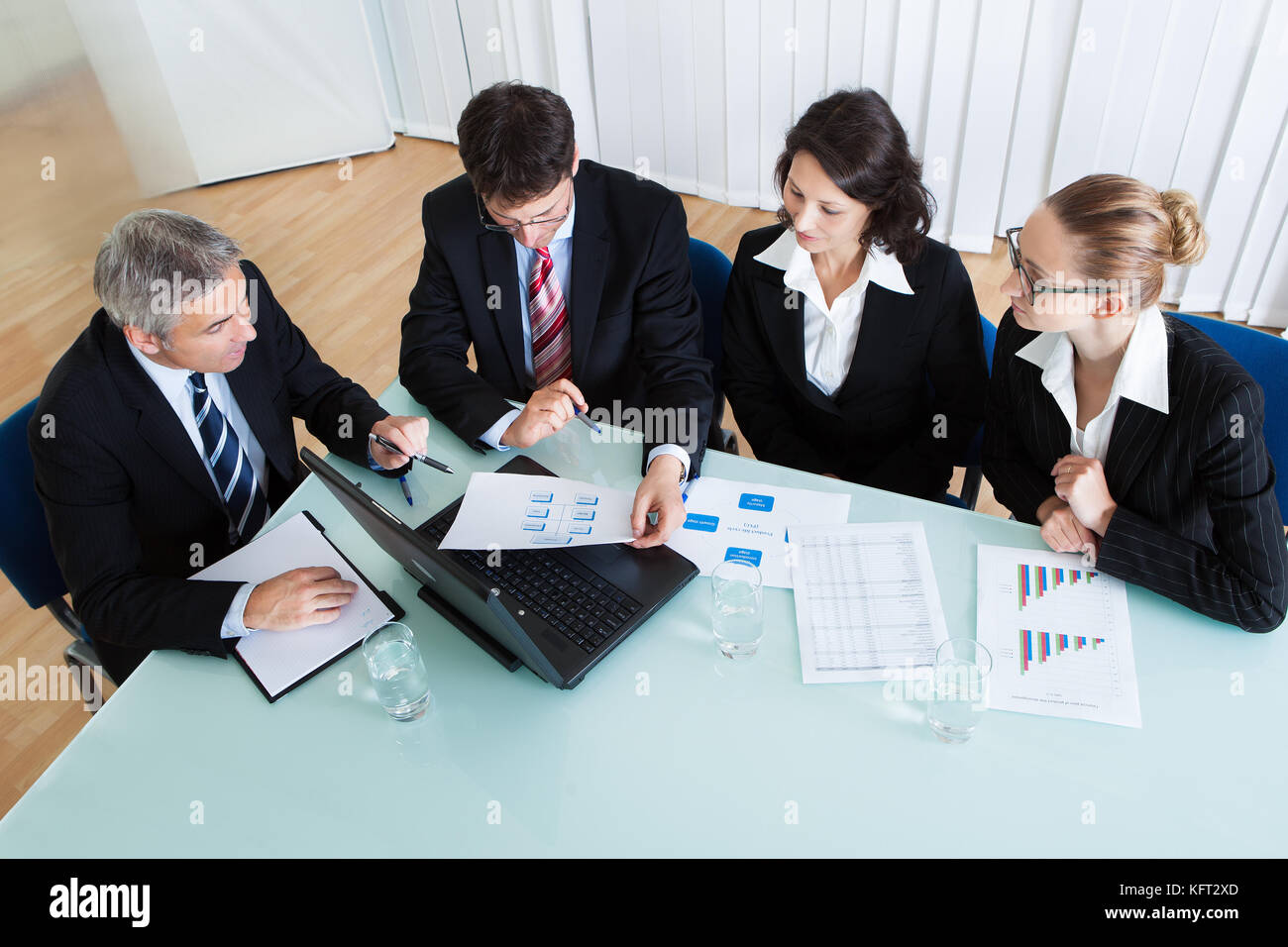 Executives brainstorming around a table hi-res stock photography and ...