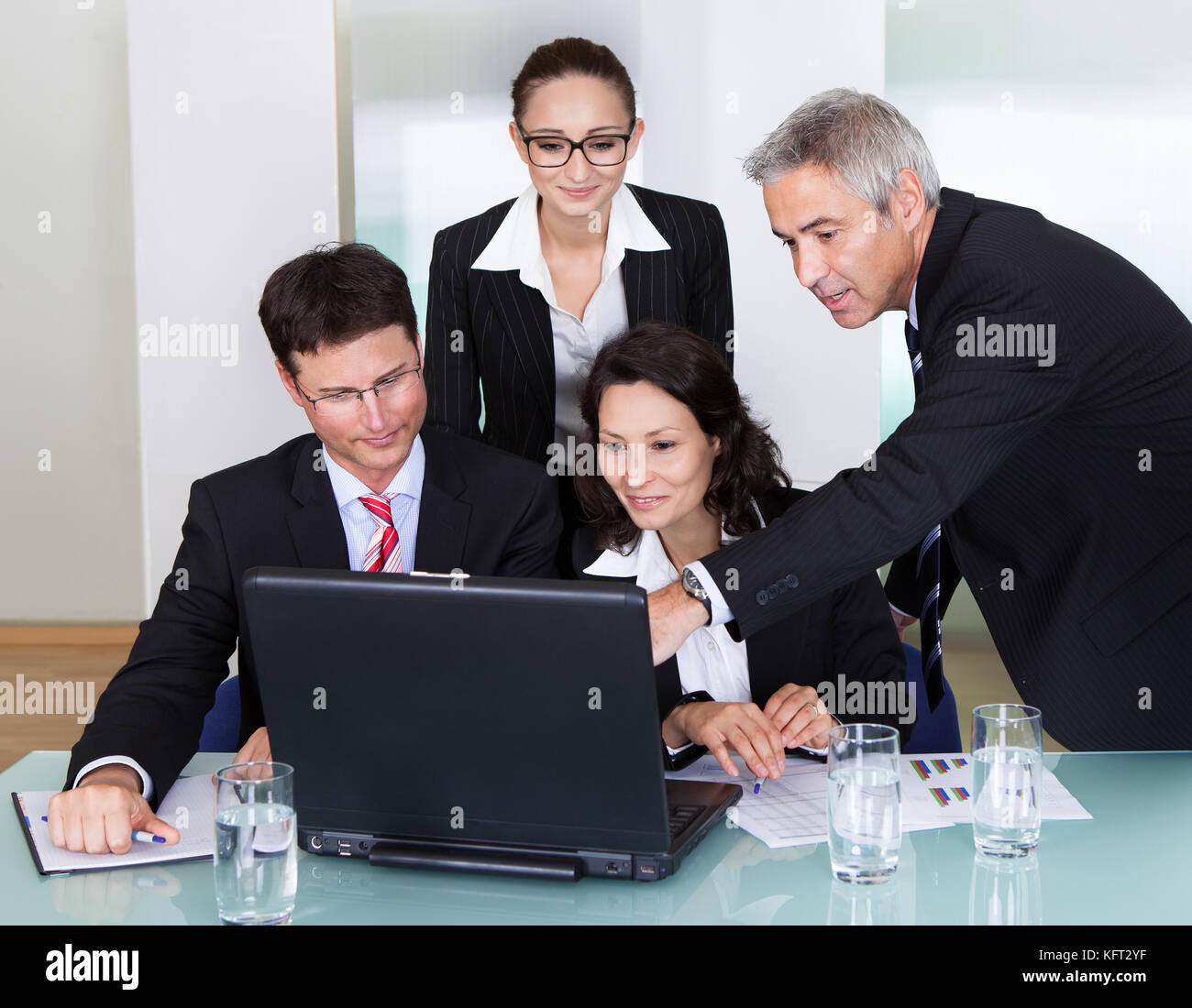 Four diverse professional businesspeople having a discussion and ...