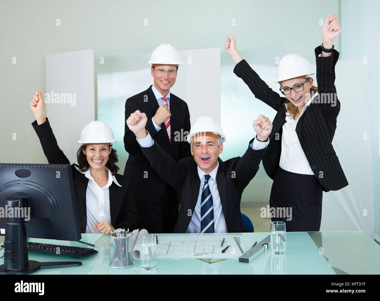 Team of four diverse architects or structural engineers wearing ...