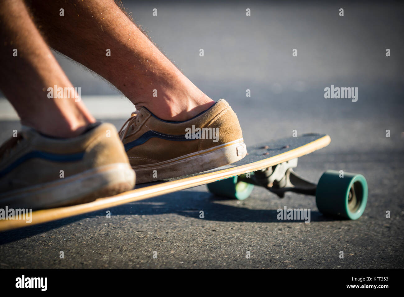 Close-up view of a skater cruising along the street on his Skateboard ...