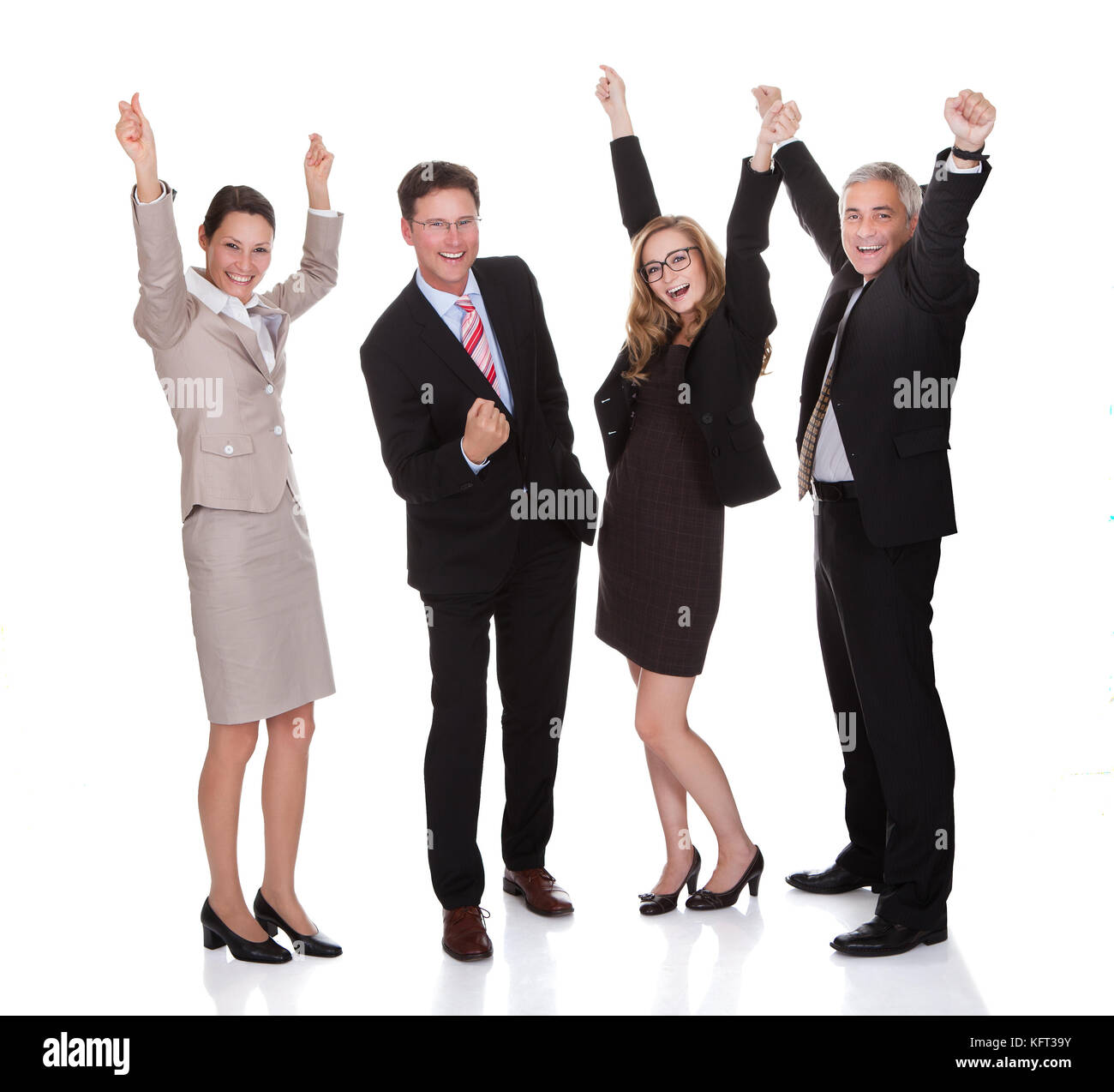 Four excited diverse professional businesspeople celebrating a success ...