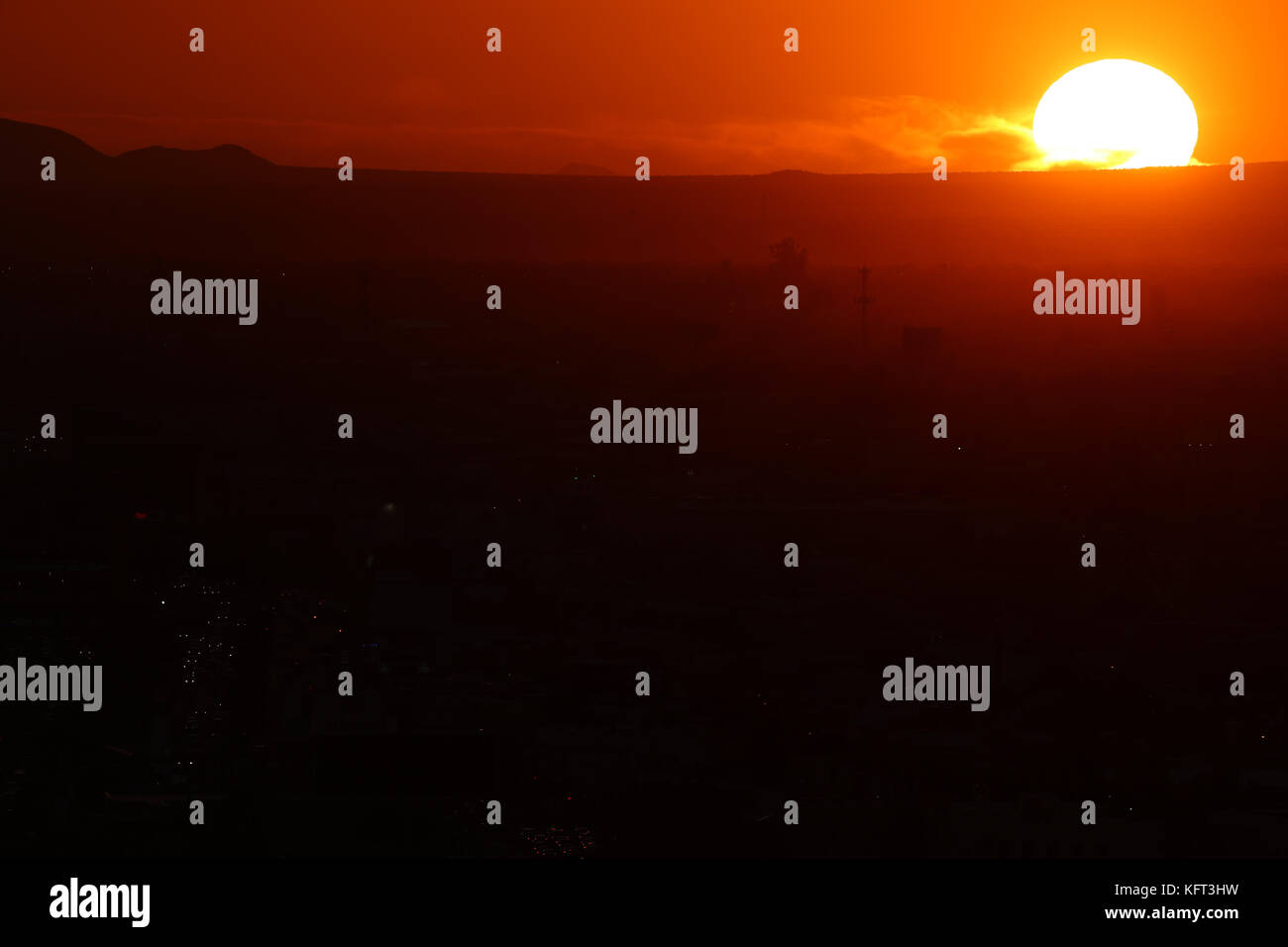 Sun and sunspots seen at sunset over the city of Hermosillo Sonora, one ...