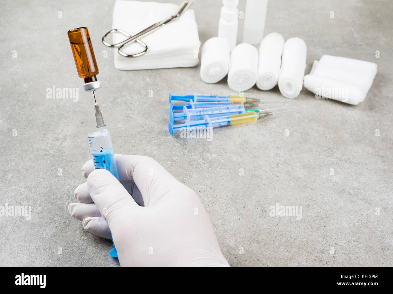 Nurse filling up an injection for the patients with other medical tools ...