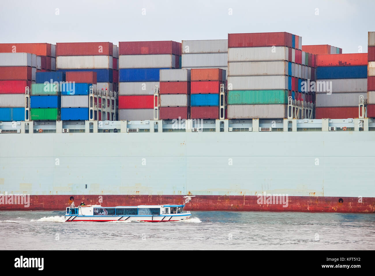 Huge container ship fully loaded in port terminal Stock Photo - Alamy