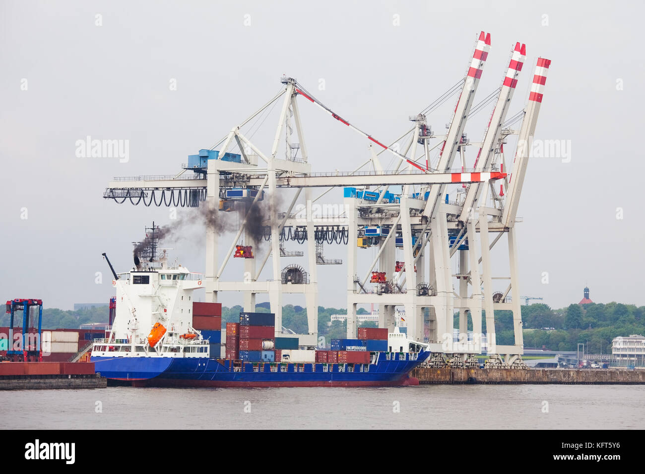 Huge container ship fully loaded in port terminal Stock Photo - Alamy