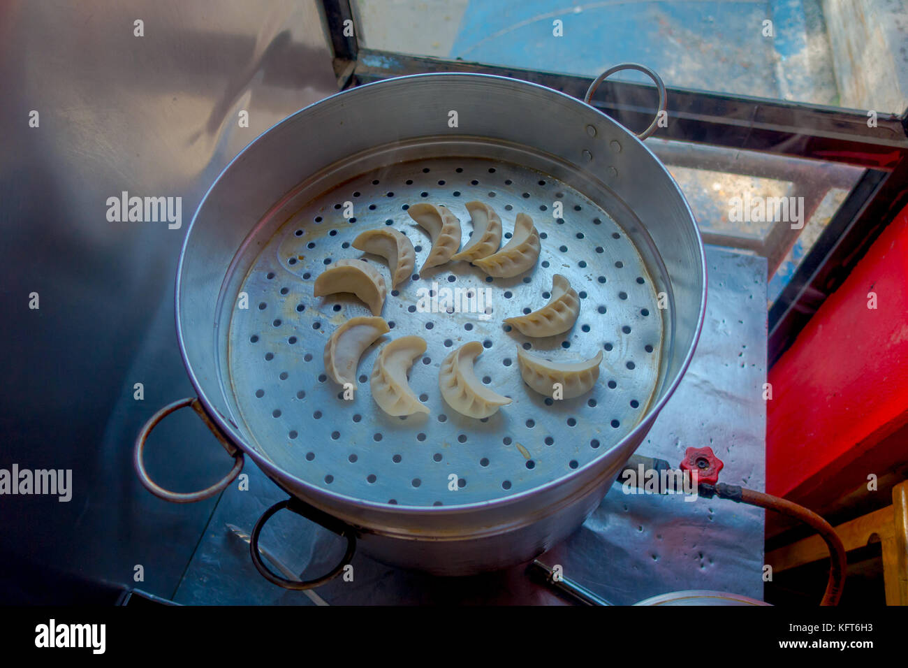 Top view of delicious momo food over a metallic tray in the kitchen ...
