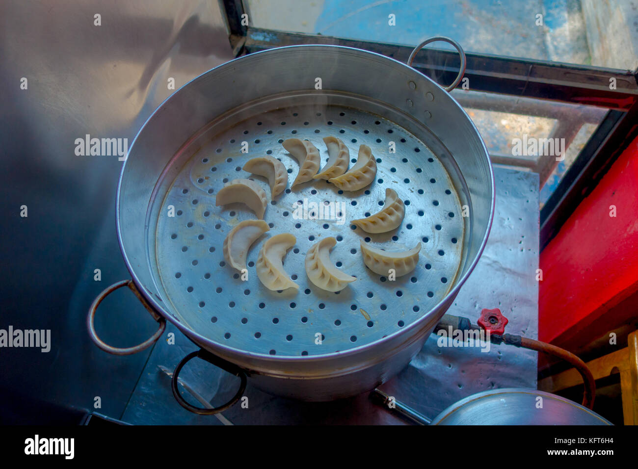 Top view of delicious momo food over a metallic tray in the kitchen ...