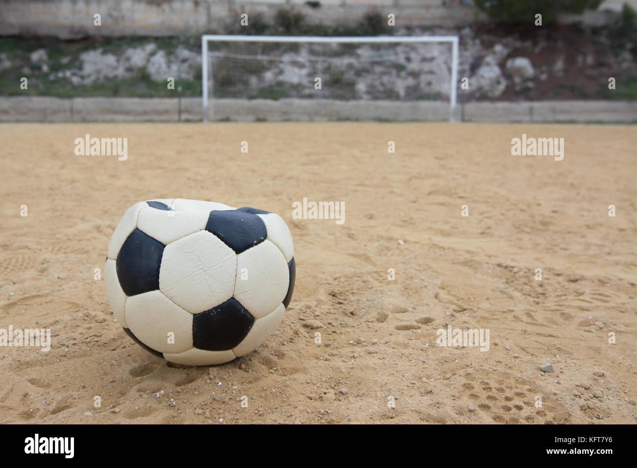 deflated ball forgotten on the football field abandoned Stock Photo - Alamy