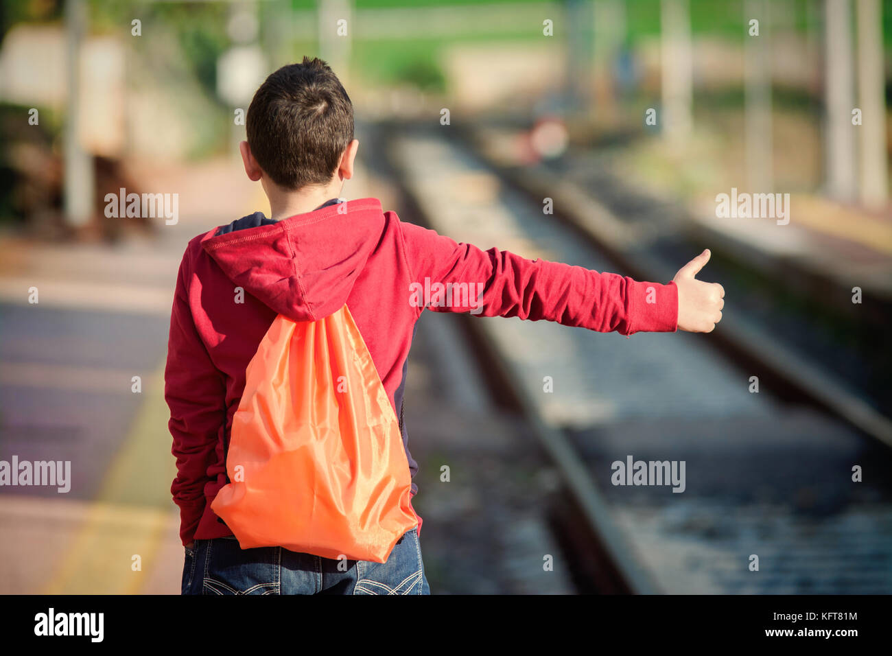 Young hitchhiker waiting of the train, standing on railway Stock Photo ...