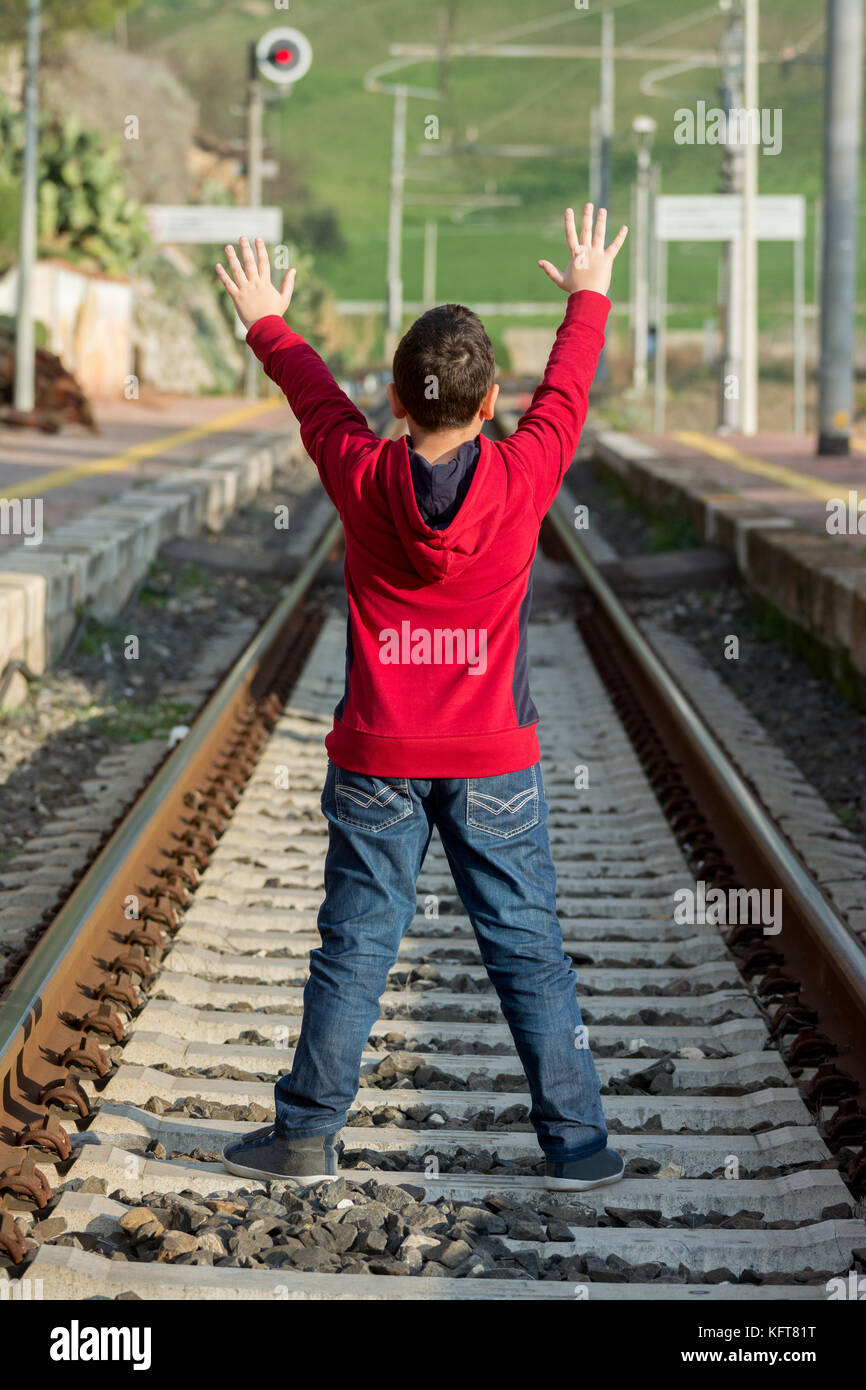 Young hitchhiker waiting of the train, standing on railway Stock Photo ...