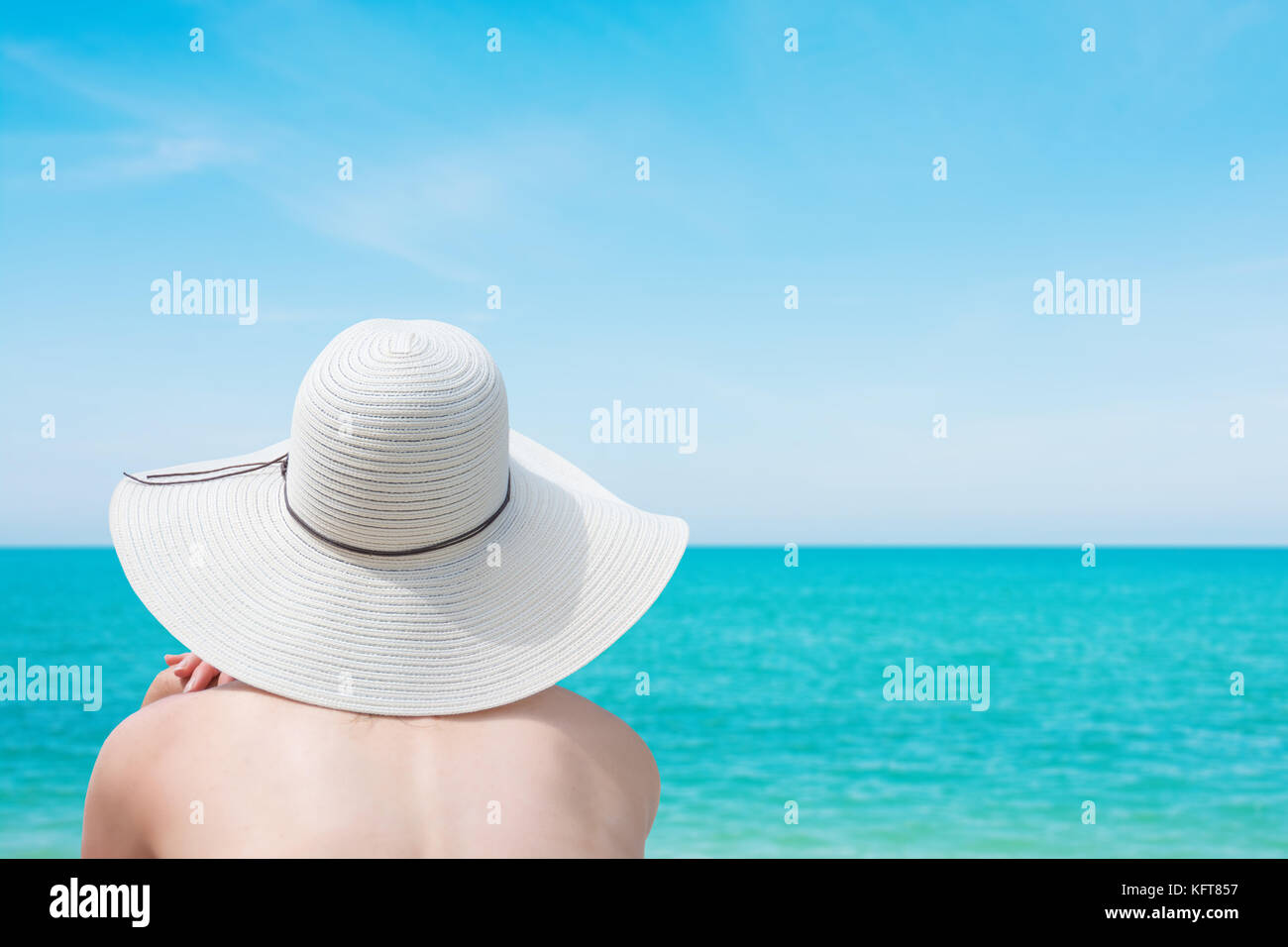 Young Woman In Swimsuit And Hat On The Beach Looking Into Distance