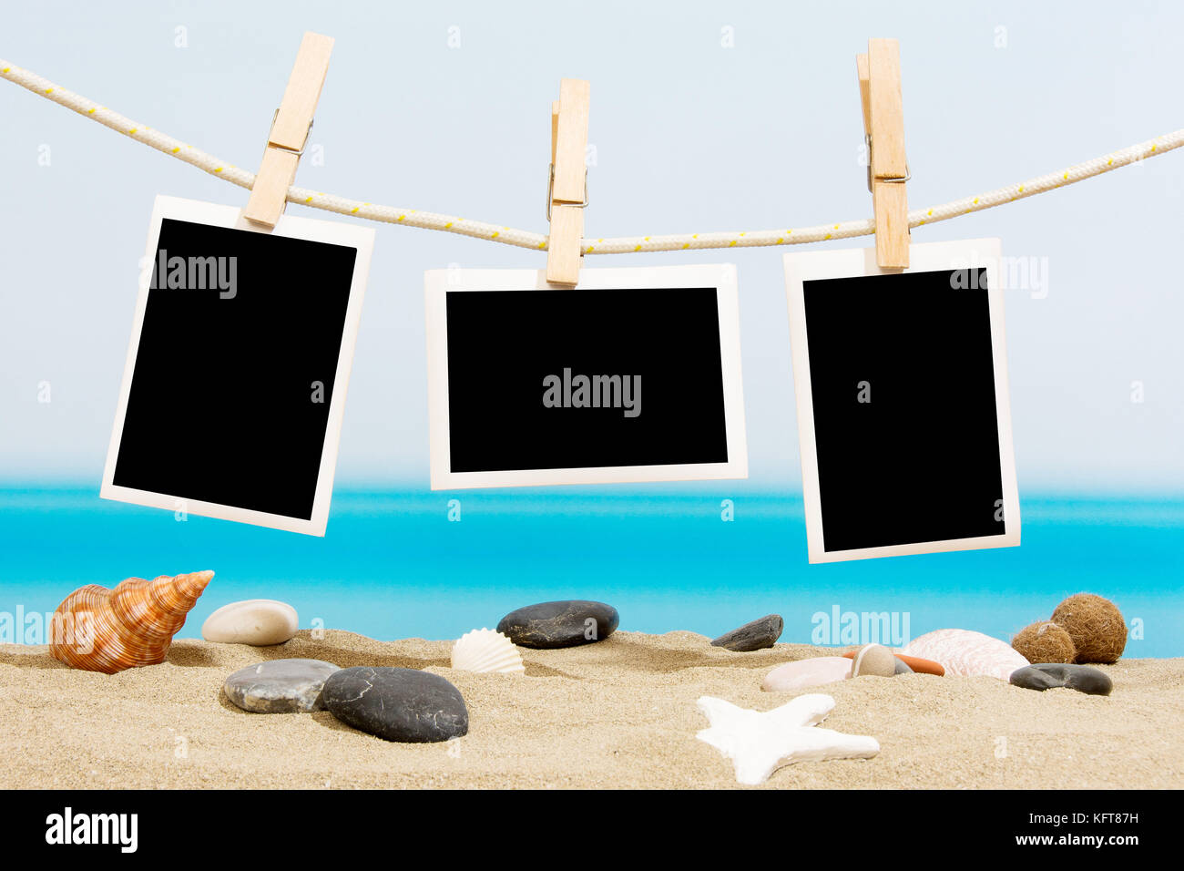 Vacation photos hanging on a rope Stock Photo - Alamy