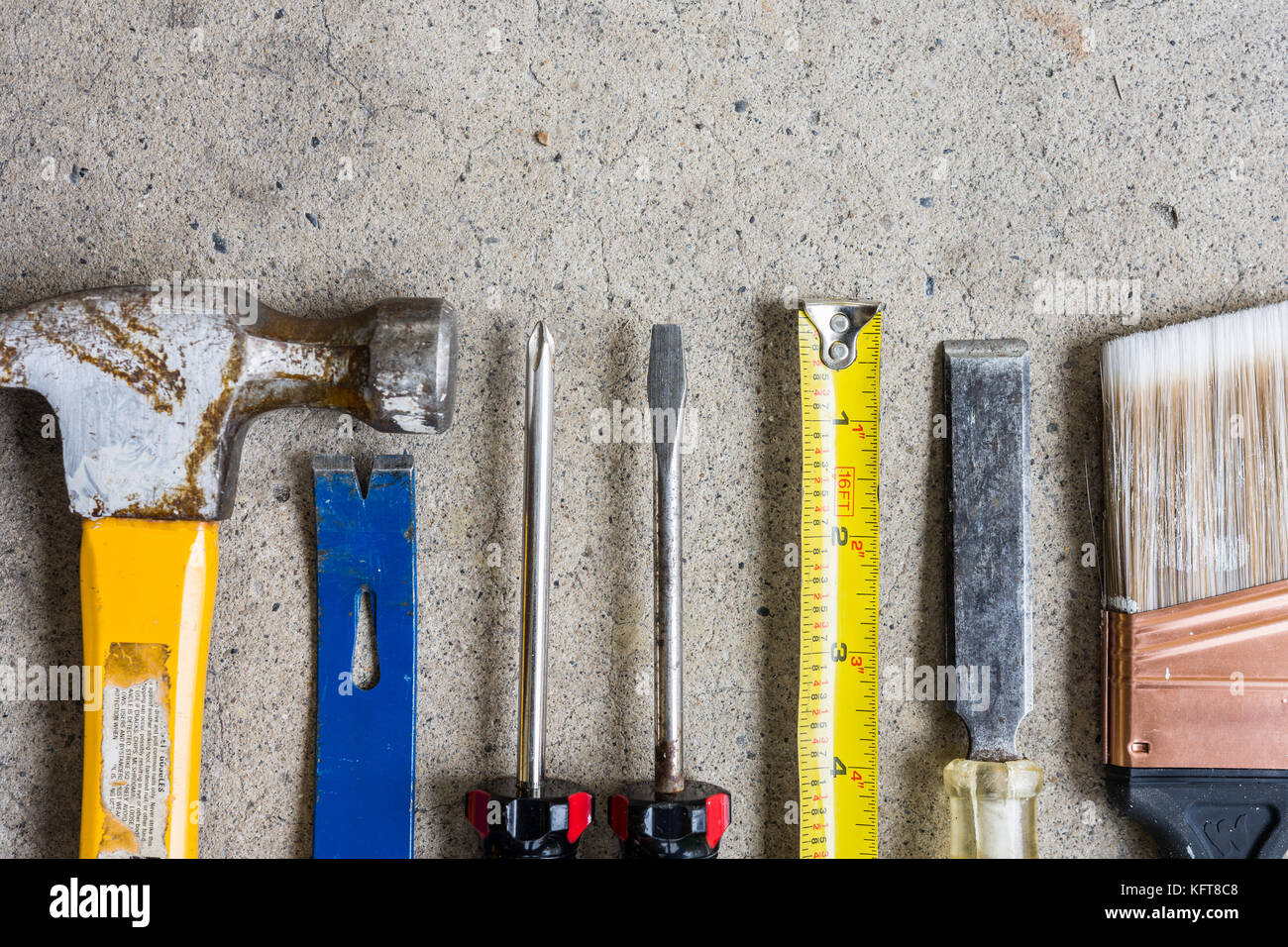 Various tools layed out on concrete background Stock Photo - Alamy