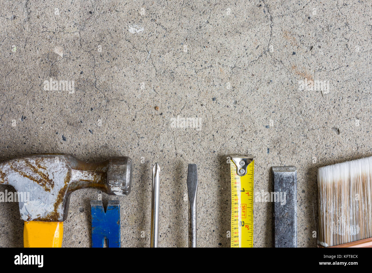 Various tools layed out on concrete background Stock Photo - Alamy