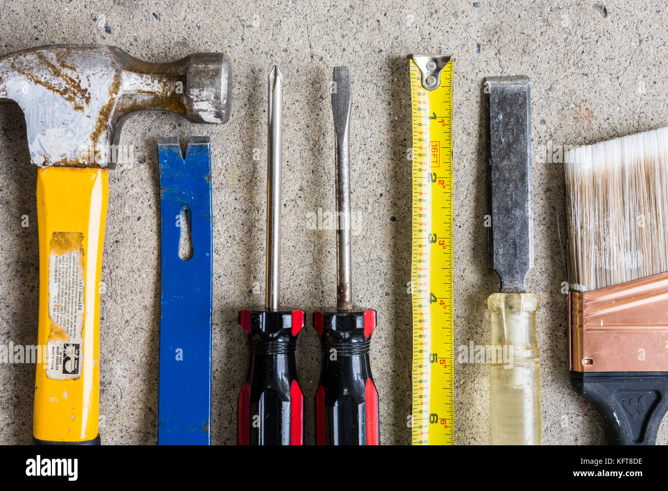 Various tools layed out on concrete background Stock Photo - Alamy