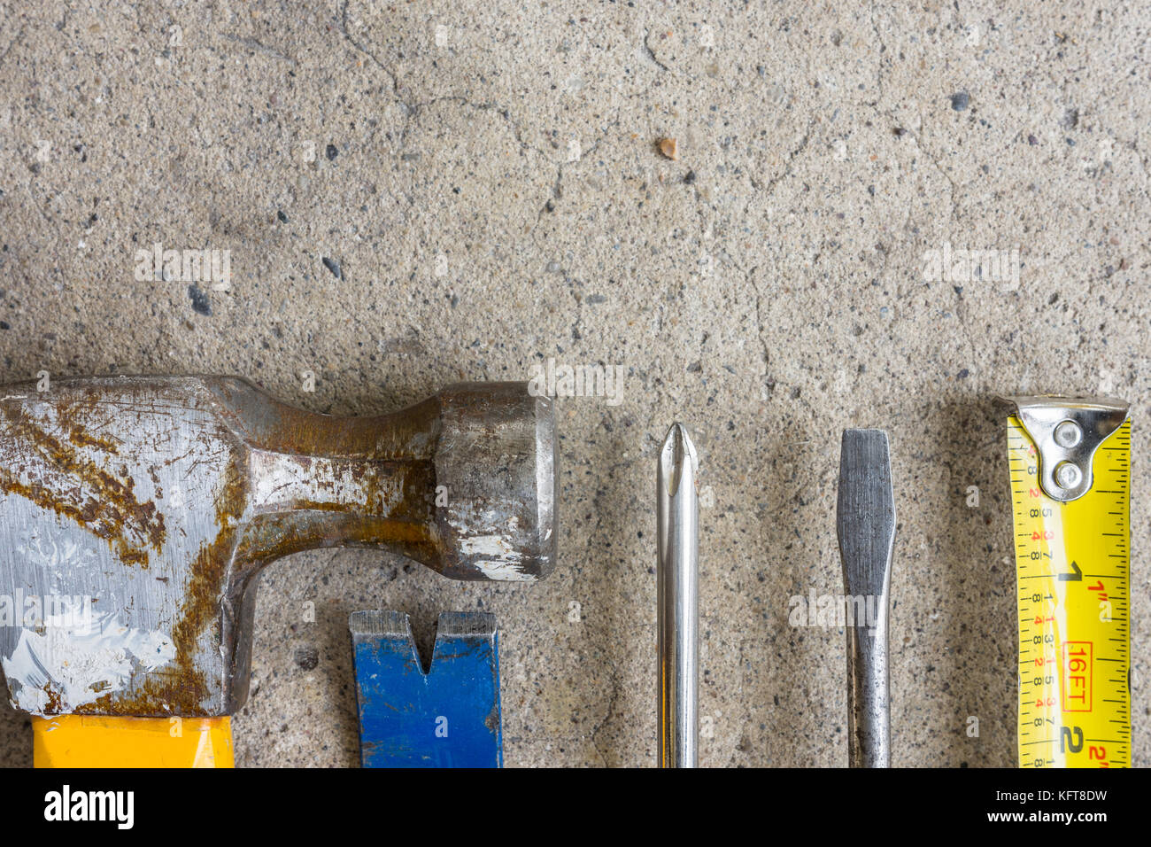 Various tools layed out on concrete background Stock Photo - Alamy