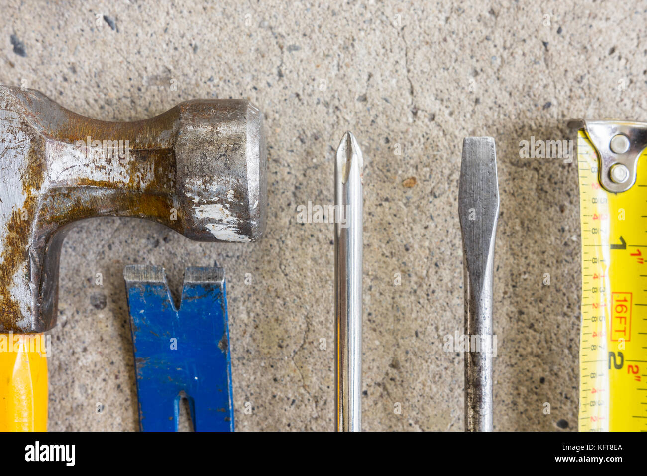 Various tools layed out on concrete background Stock Photo - Alamy