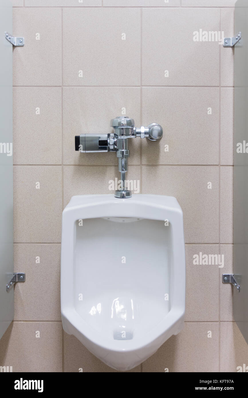White porcelain urinal on tile background Stock Photo - Alamy