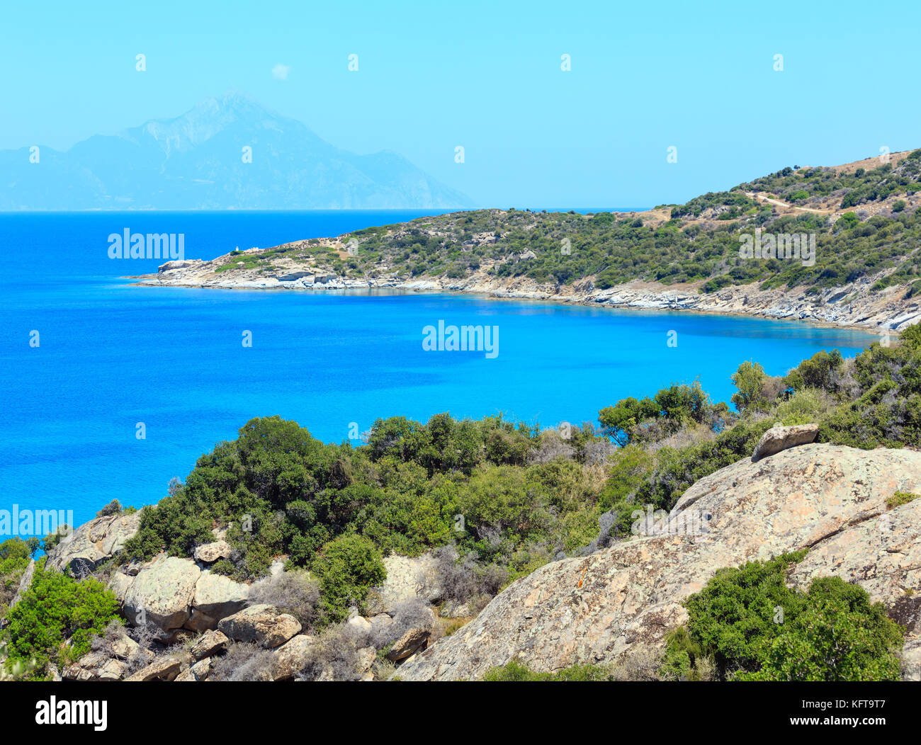 Summer sea scenery with aquamarine transparent water and Athos Mount ...