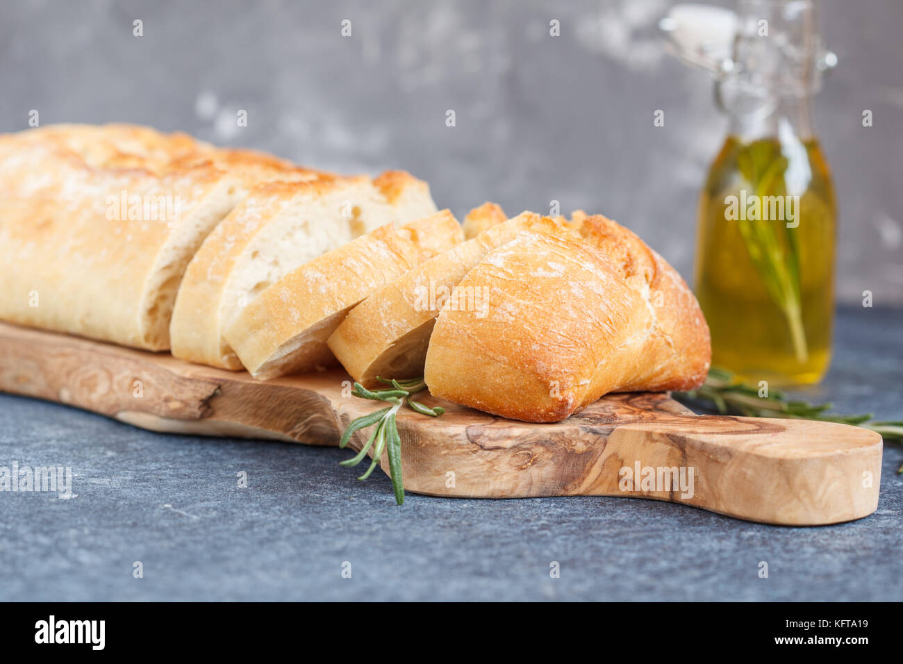 Italian ciabatta and traditional Italian ingredients on a wooden board ...