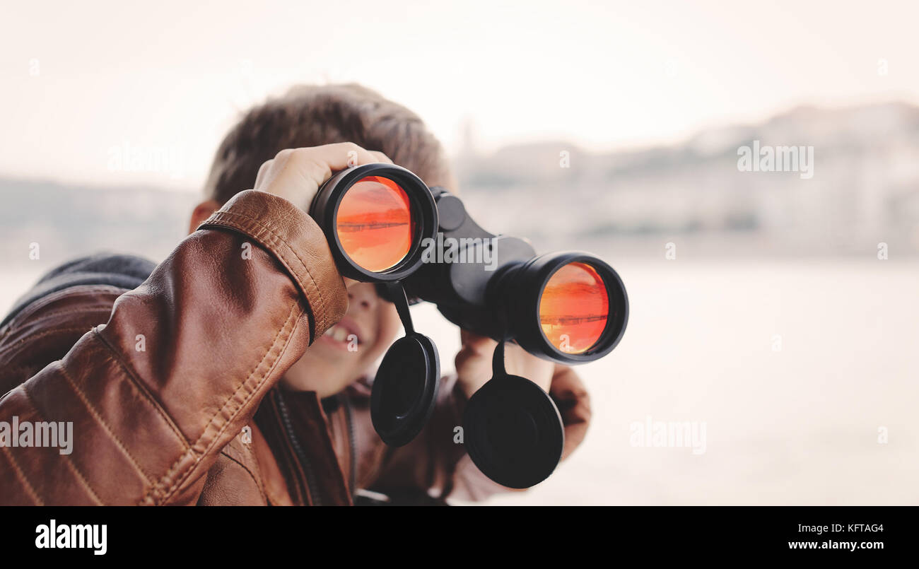 Little caucasian boy watching, looking, gazing, searching for by ...