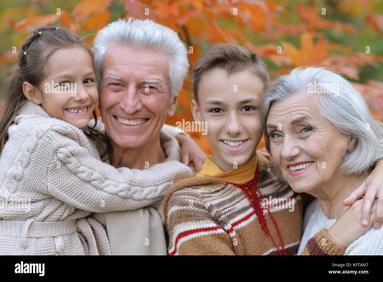 grandfather, grandmother and grandchildren in park Stock Photo - Alamy