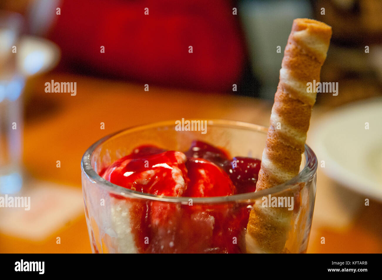 Ice cream with strawberry syrup Stock Photo - Alamy