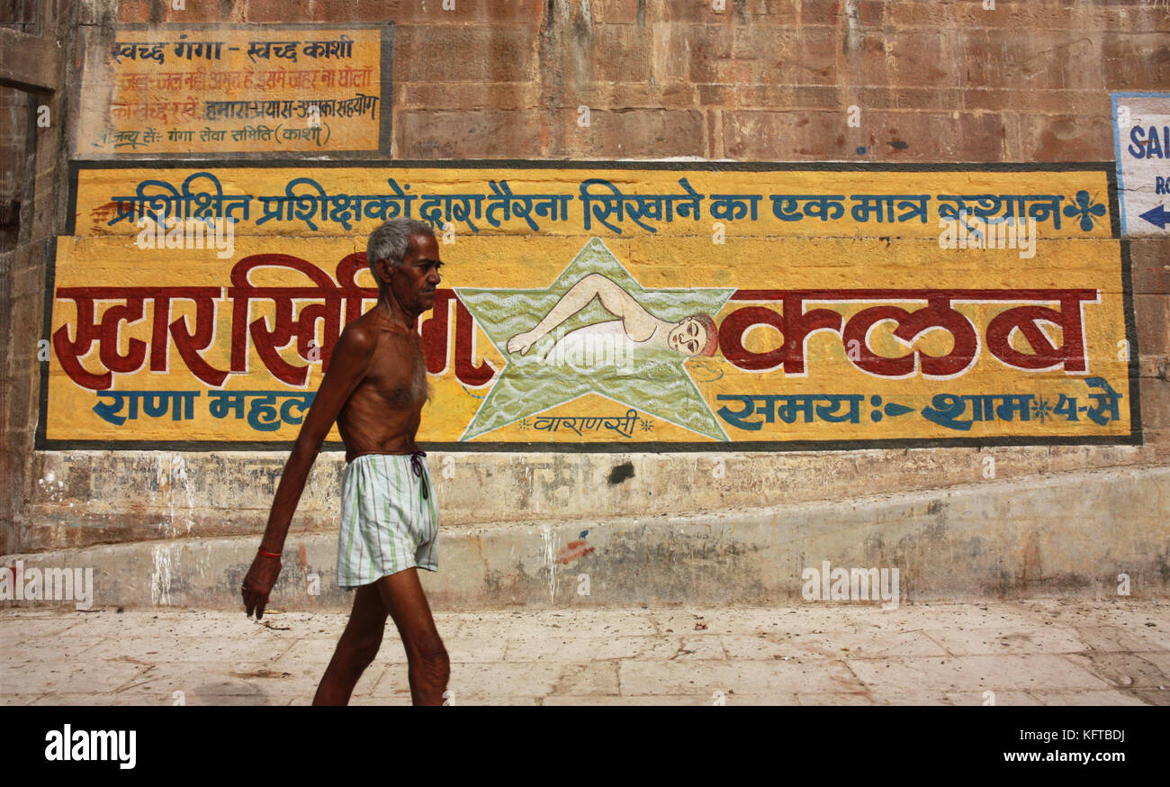 Man walks along the ghats heading for Varanasi Swimming Club on the ...