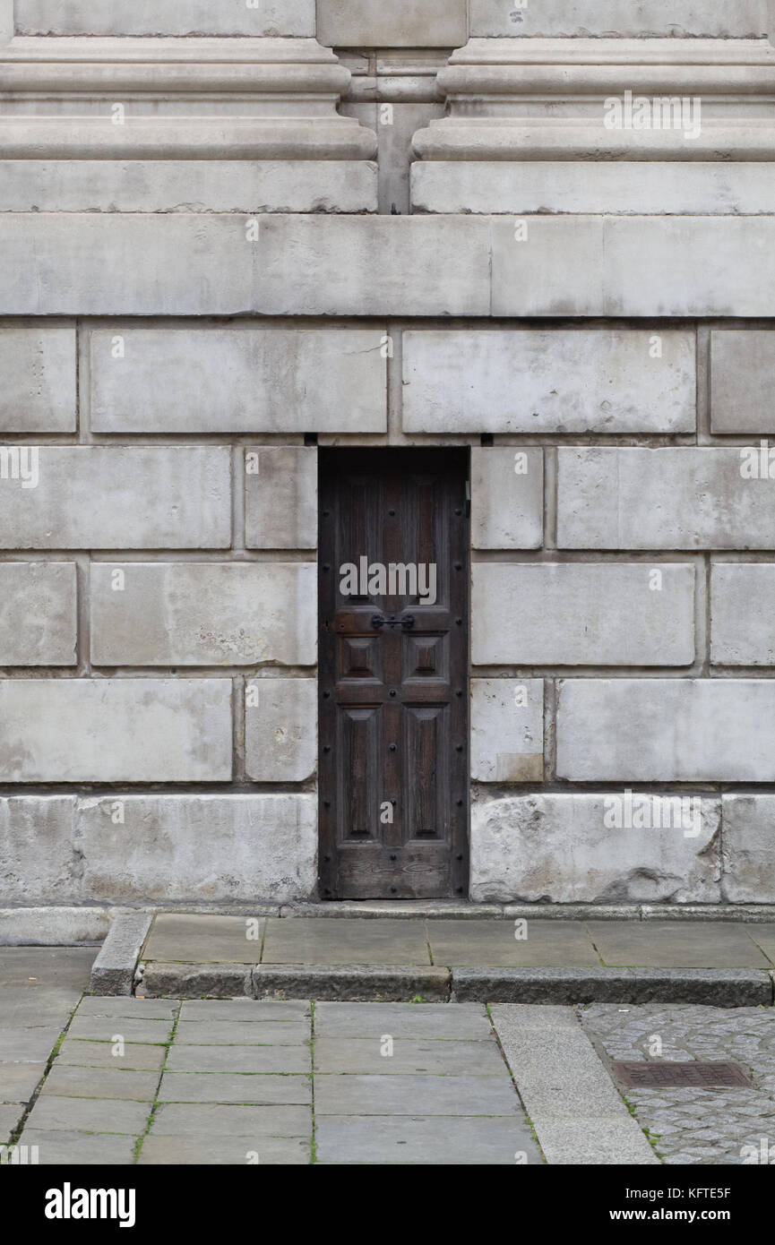 small wooden door and a portland stone building Stock Photo - Alamy