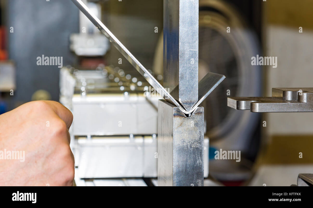 worker operating metal press machine at workshop Stock Photo - Alamy