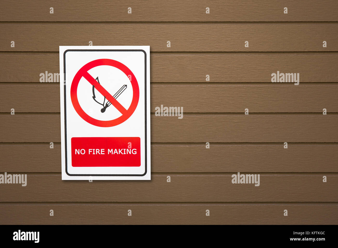 No Fire signs ON WOOD no smoking in city Stock Photo - Alamy