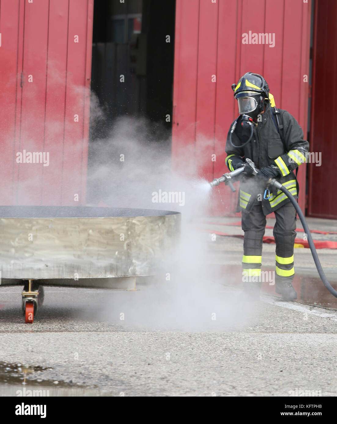 brave firefighter with foaming dispenser turns off fire during rescue ...