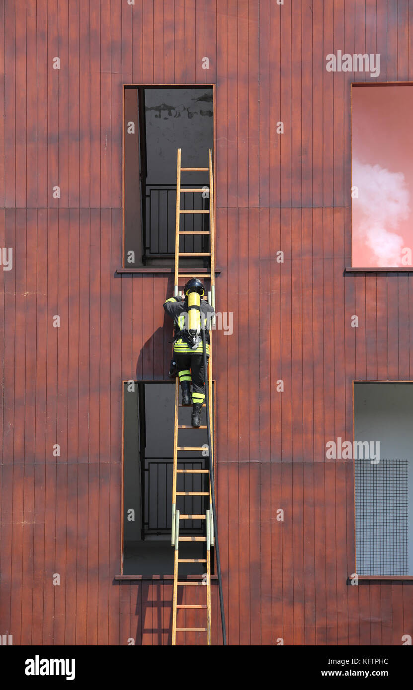 firefighter with the mask and the oxygen cylinder while entering the ...