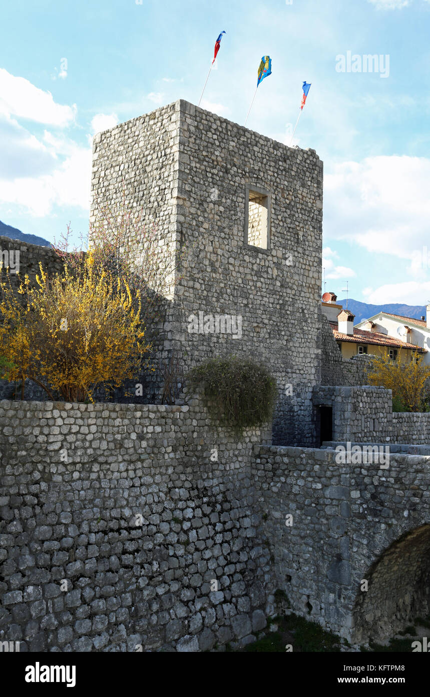 three flags on the ancient tower of the middle age wall in the little ...