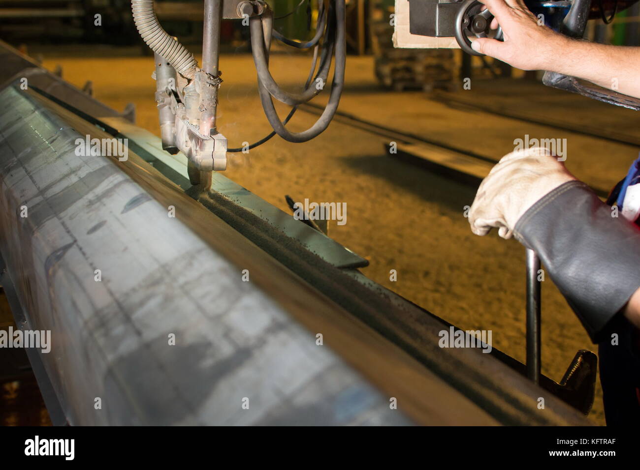 Male worker operating automated steel welding machine Stock Photo - Alamy