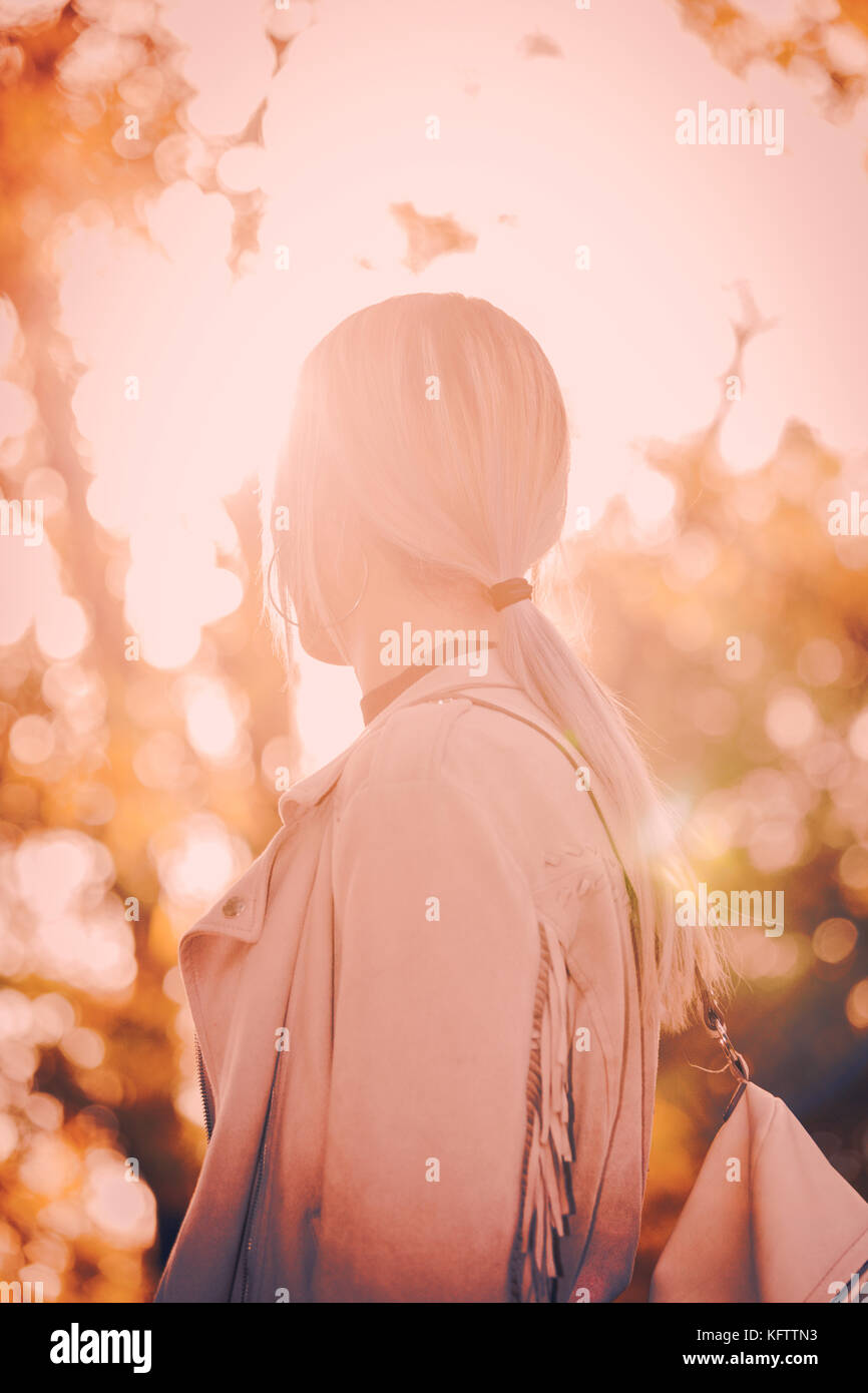 Woman back side portrait outdoors nature peaceful. She is looking at ...