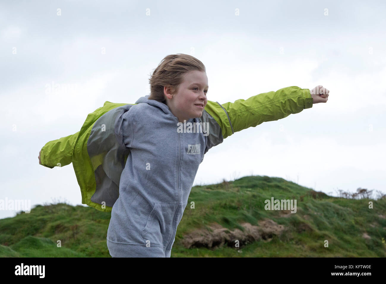 boy fighting the wind, Ballintoy, Co. Antrim, Northern Ireland Stock ...
